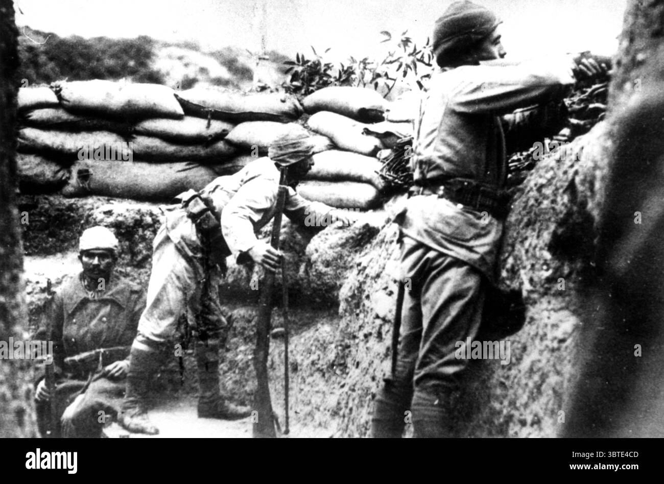 As his comrade watches closely , a Turkish soldier fires over his ...