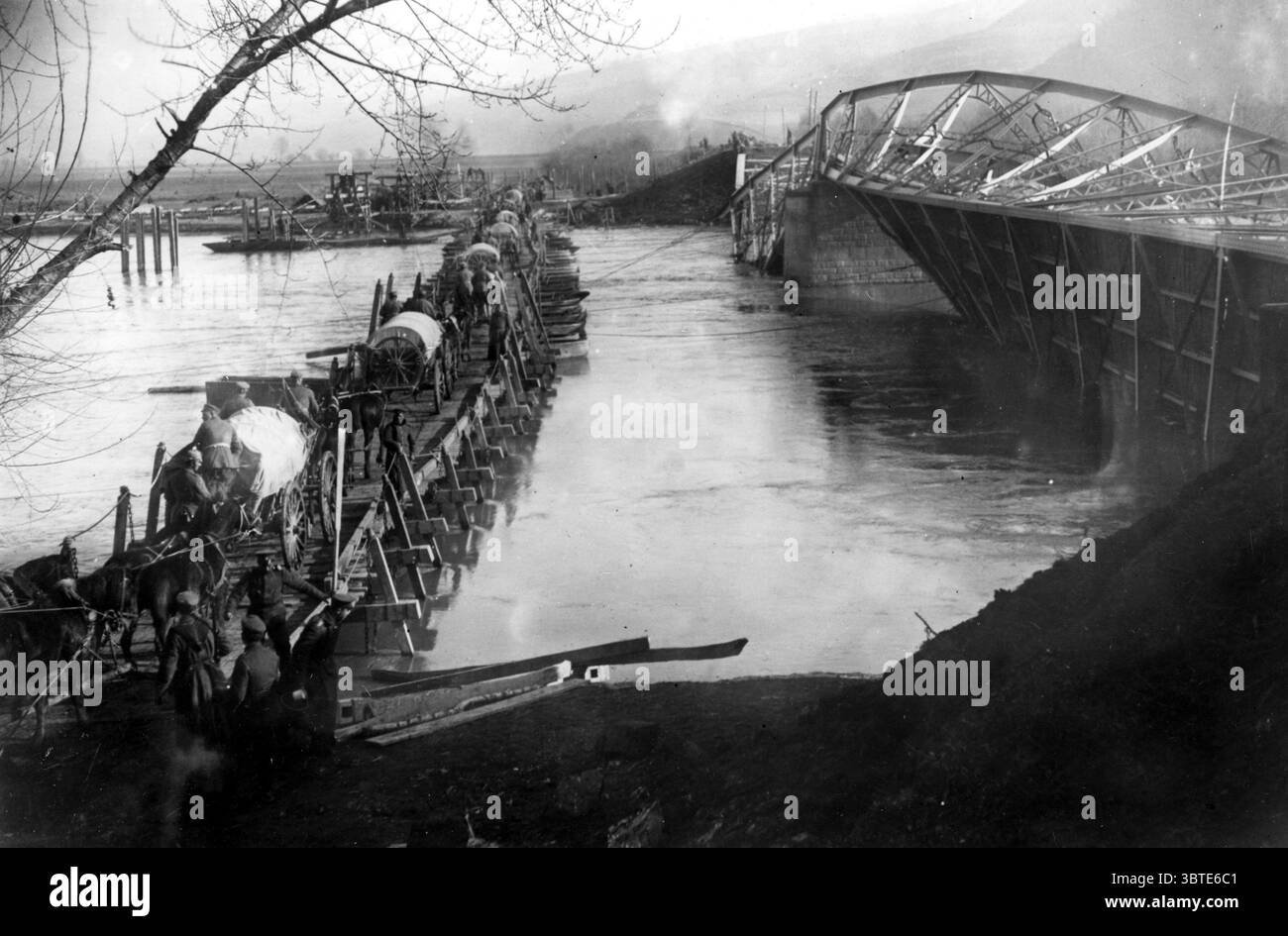 Transport crossing a pontoon bridge built by German pioneers alongside ...