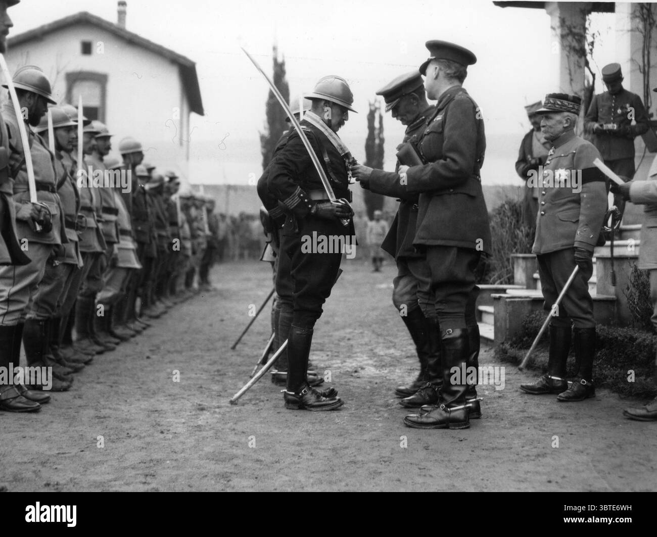 General Sir Bryan Mahon decorating French Colonel Aldebert , being made ...