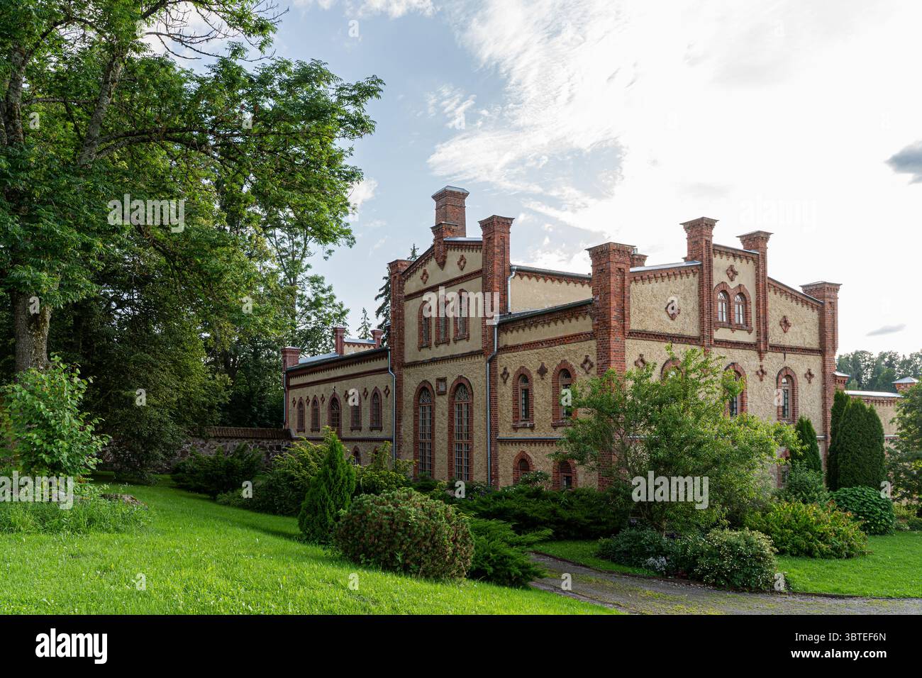 Rear view of Mooste Distillery, a historic red brick and stone building ...