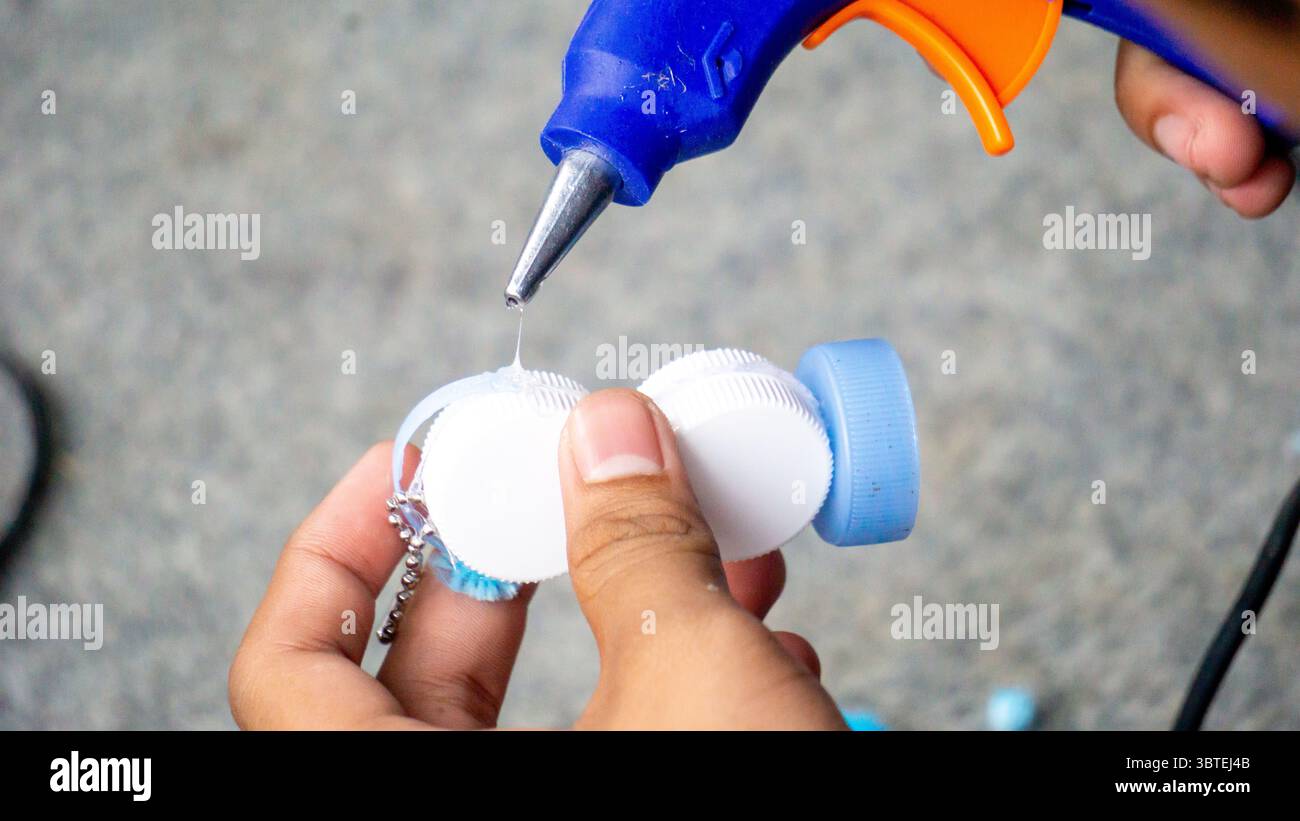 Making key chains from bottle caps and flannel. Recycling plastic ...