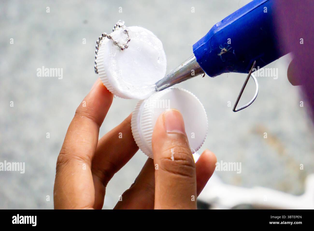 Making key chains from bottle caps and flannel. Recycling plastic ...
