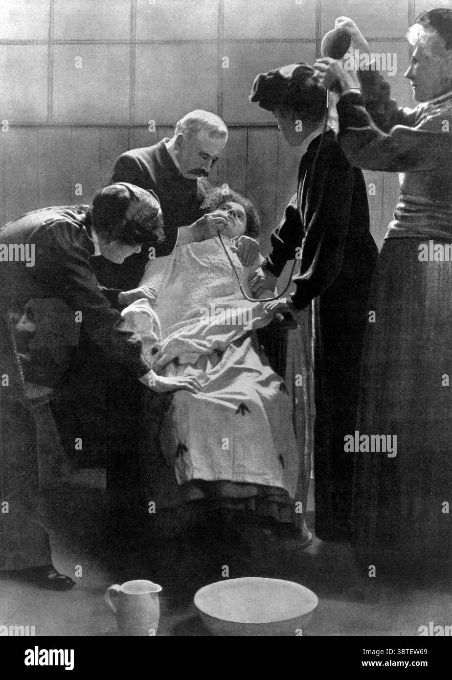 A woman Suffragette prisoner being force fed with a tube 1912 Stock ...