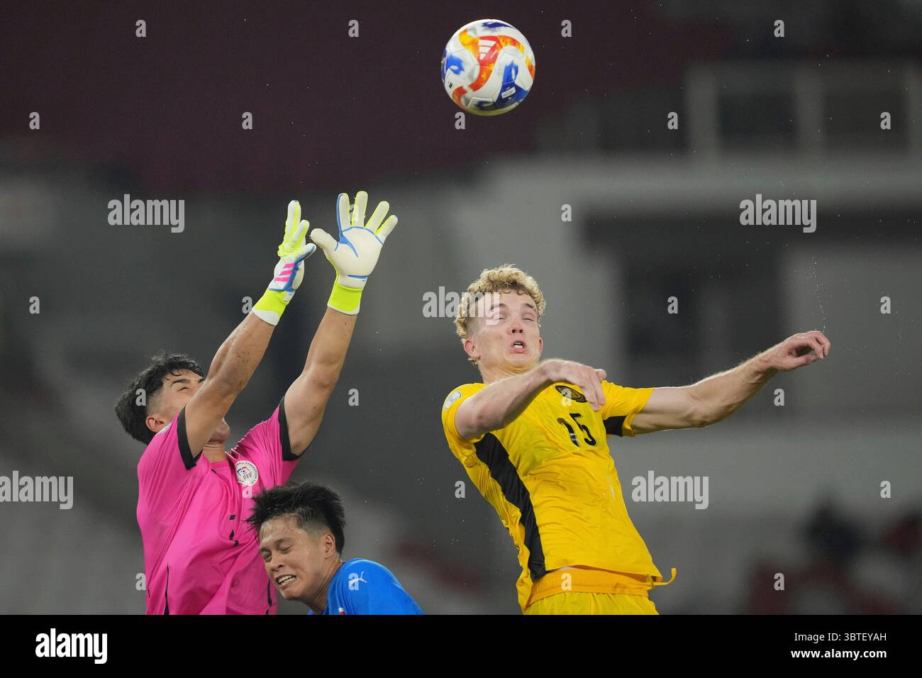 Malaysia's Fergus Tierney, right, battles for the ball against ...