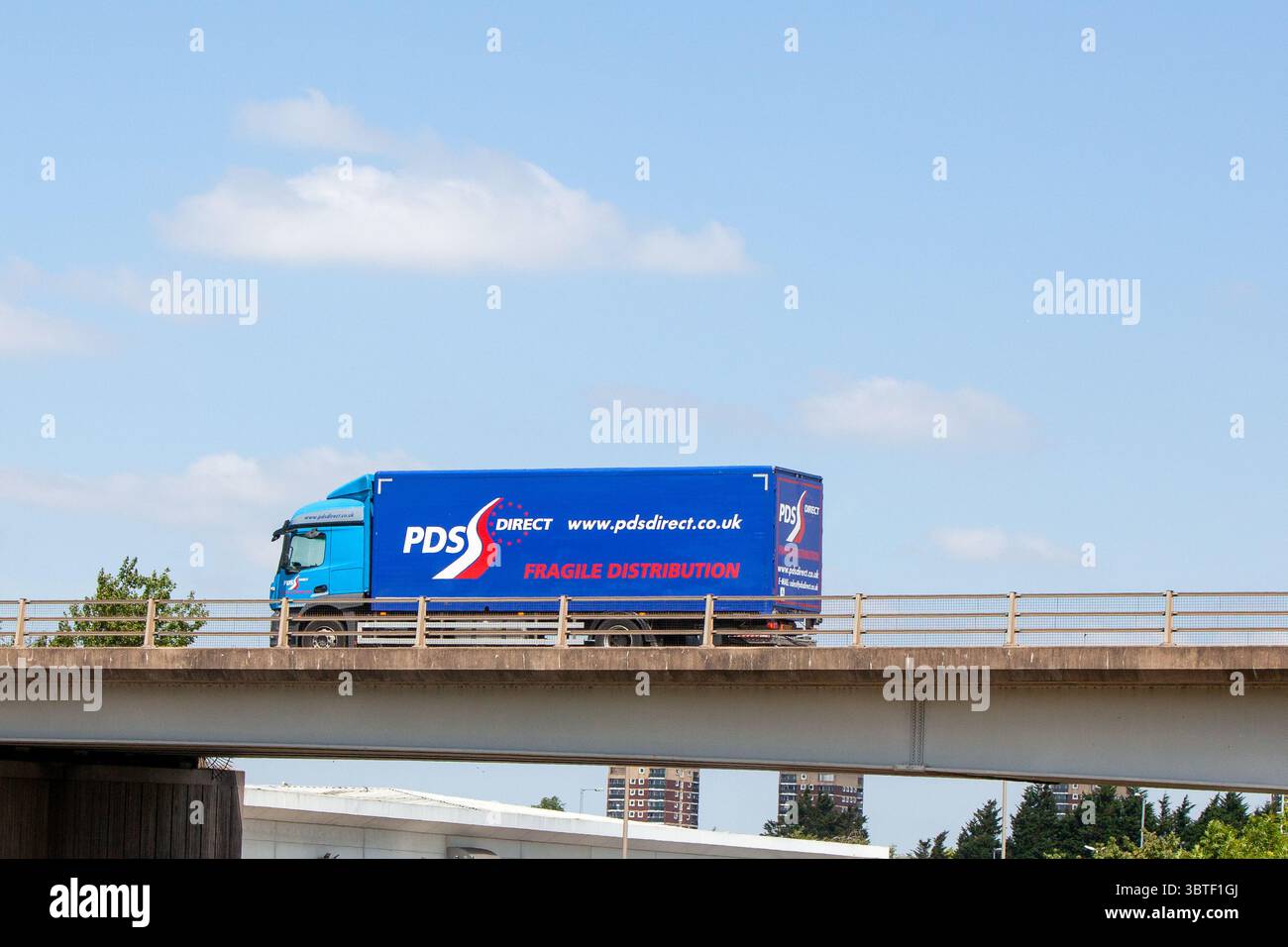 A blue PDS Direct rigid sided truck with "Fragile Distribution ...