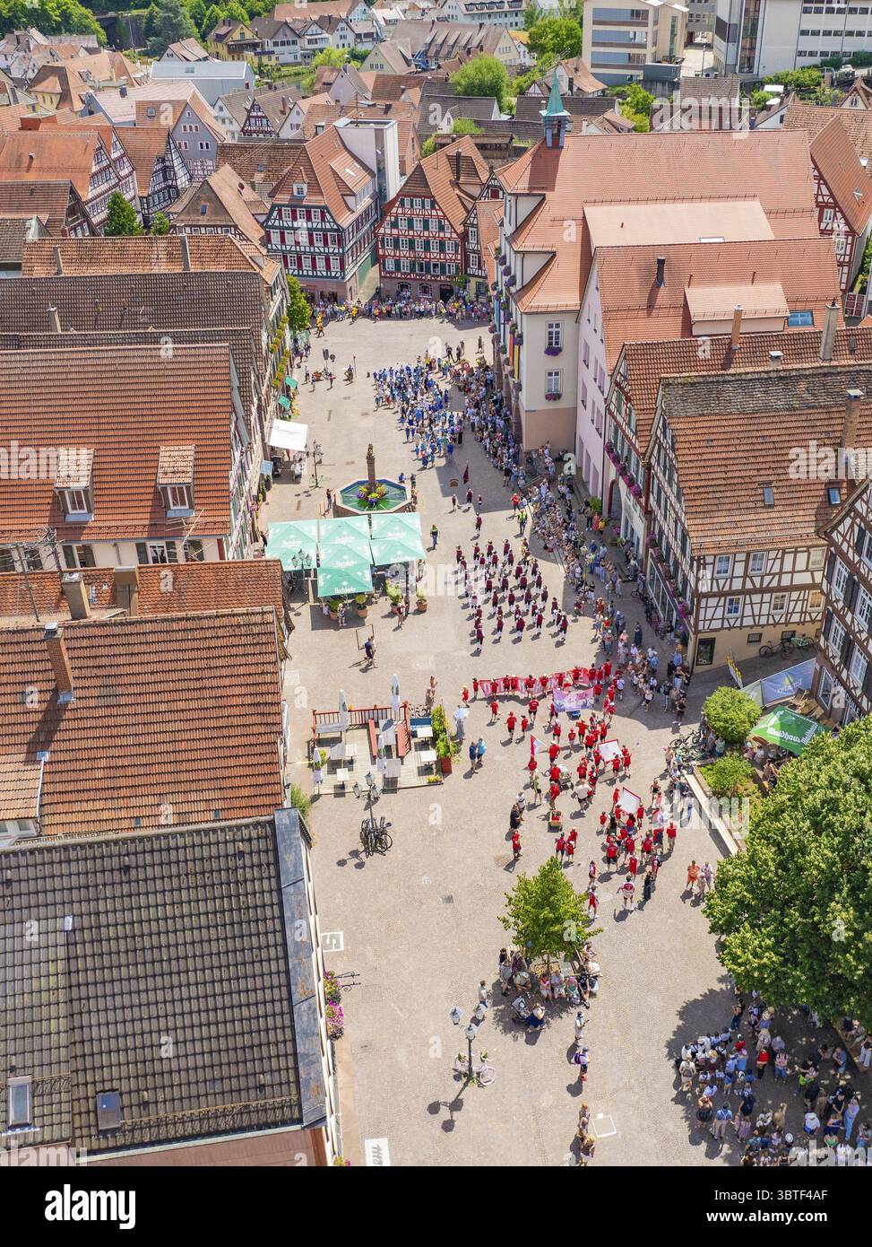 Aerial view of an old town with half-timbered houses and a gathering of ...
