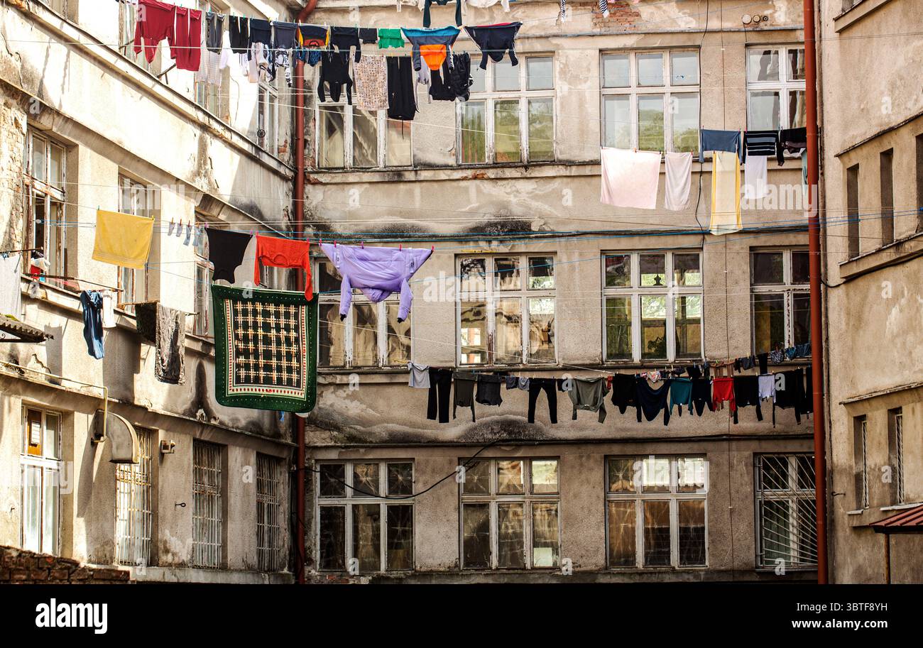 Poor district. Washed clothes drying outside of an old house. Poor ...