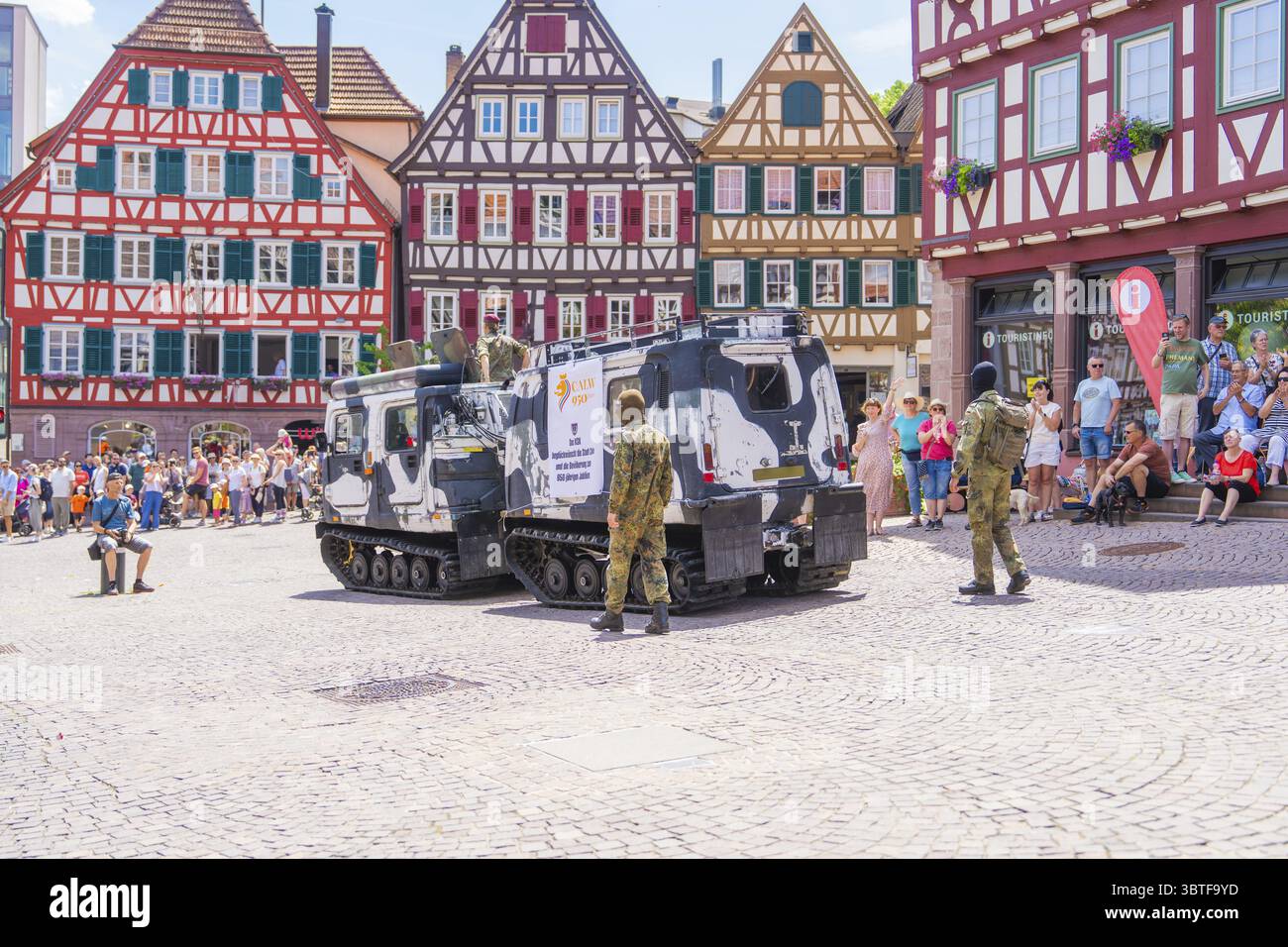 Armoured vehicles stand on a town square with half-timbered buildings ...