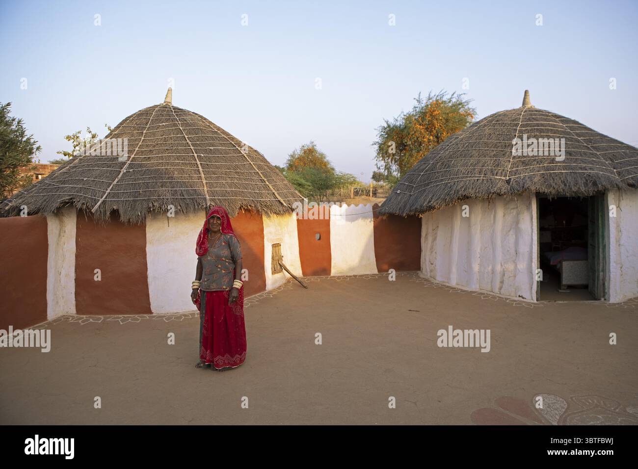 Indian woman, 55 years old, desert dweller, behind typical round ...