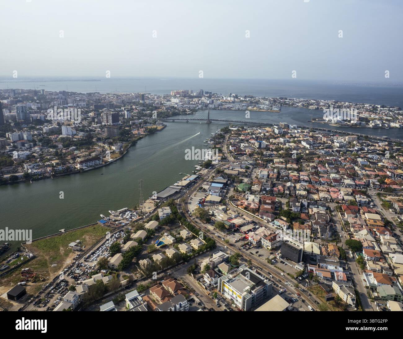 Aerial view of Lekki Phase 1 bridge spanning the waterway, connecting dense urban areas under a ...