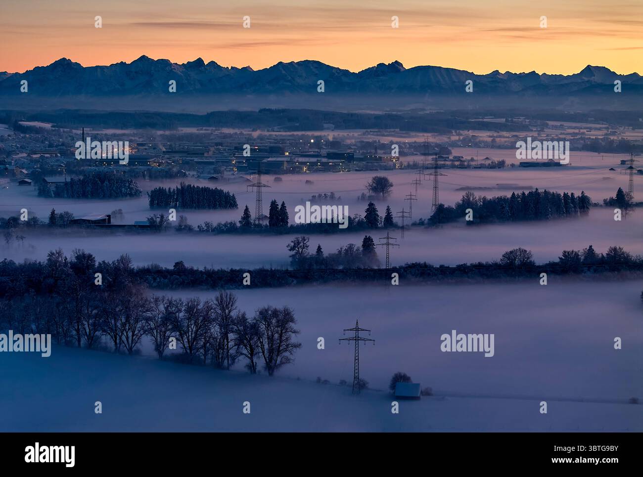 Aerial view of the undulating landscape blanketed in ethereal fog ...