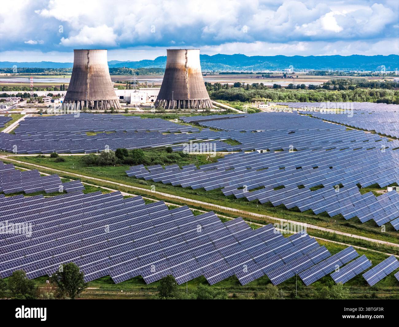 Aerial view of solar panels gleaming under a vast sky, juxtaposed ...