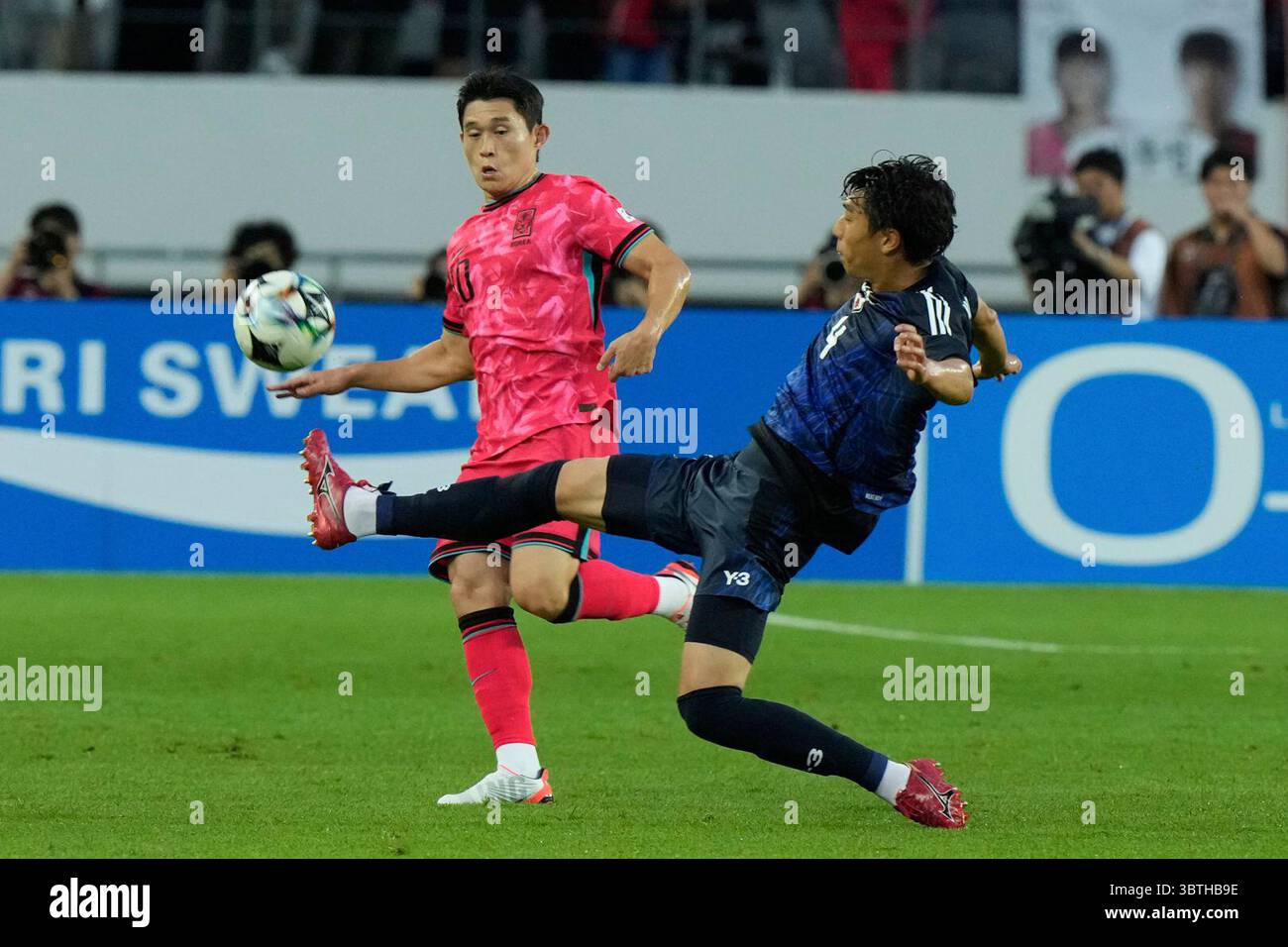 South Korea's Lee Dong-gyeong, left, fights for the ball against Japan ...