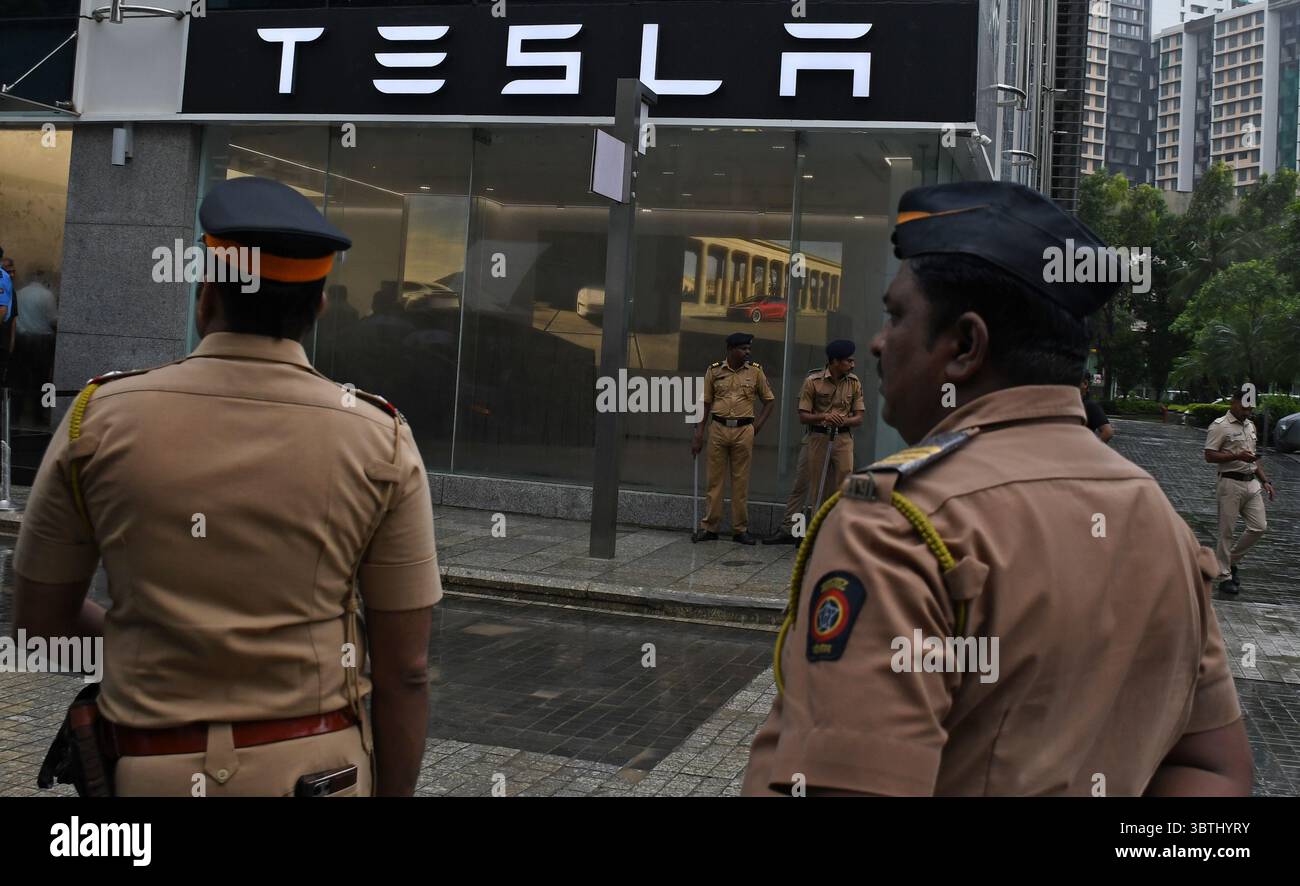 Mumbai, India. 15th July, 2025. Policemen stand outside the Tesla ...