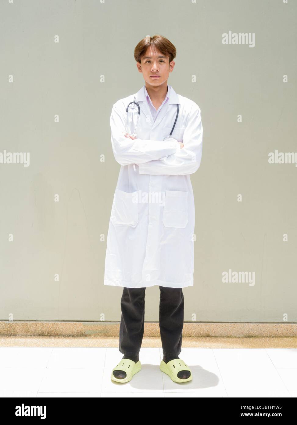 Young Asian healthcare worker wearing lab coat full body portrait Stock ...