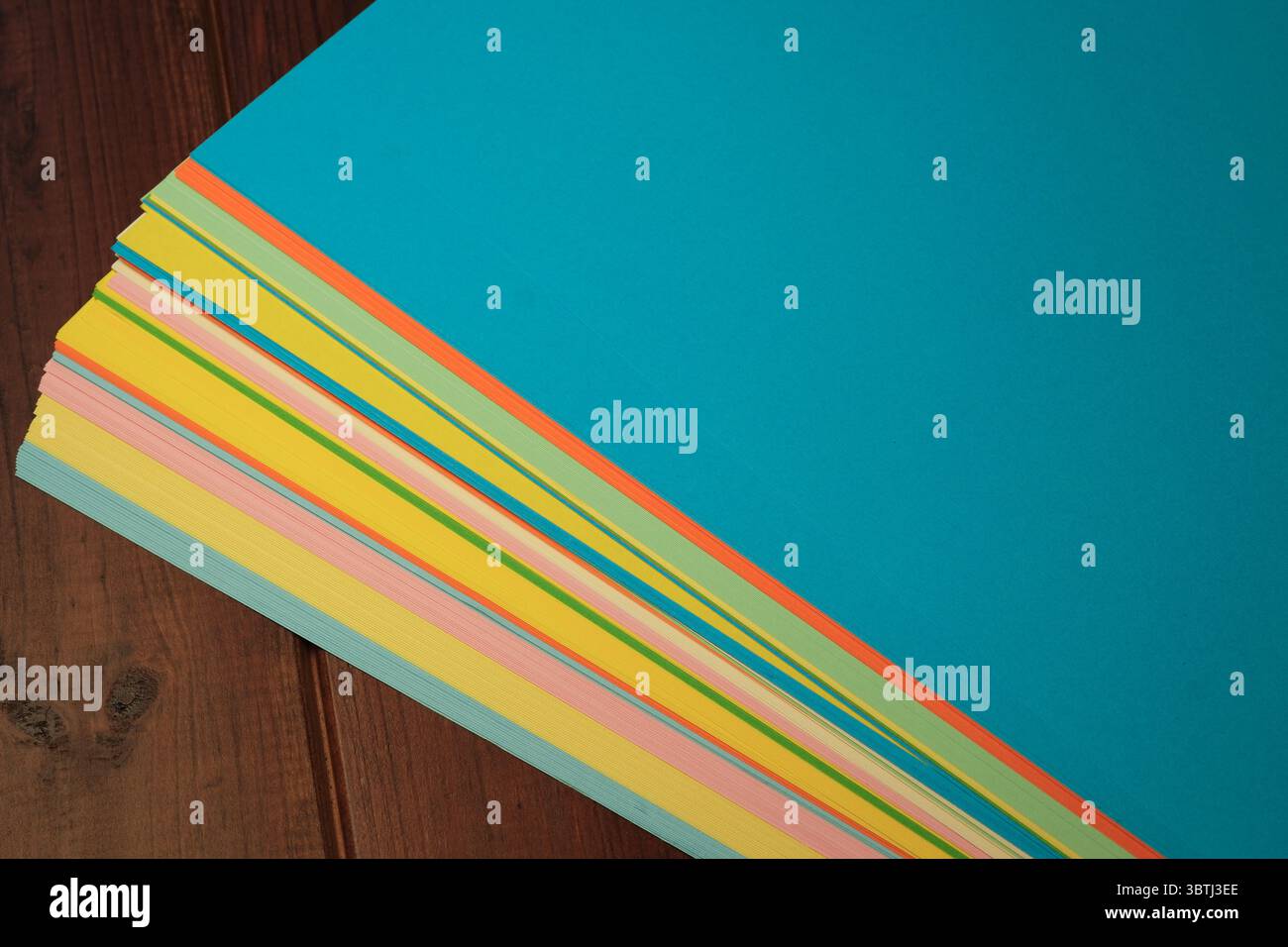 Brightly colored paper stacked at an angle, inviting artistic endeavors ...