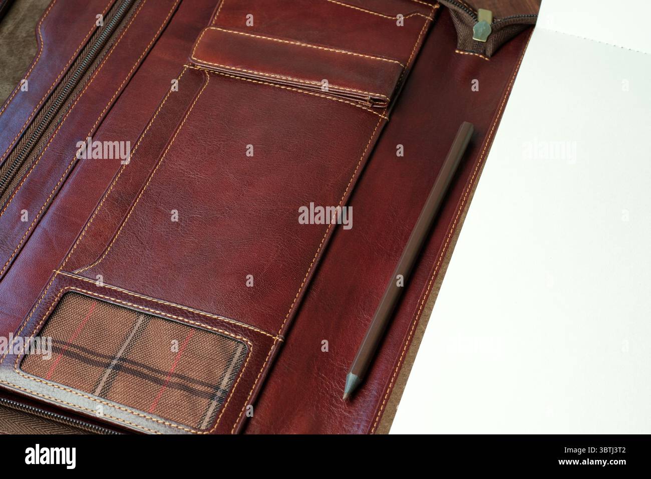 A sophisticated leather portfolio displays various compartments and a ...