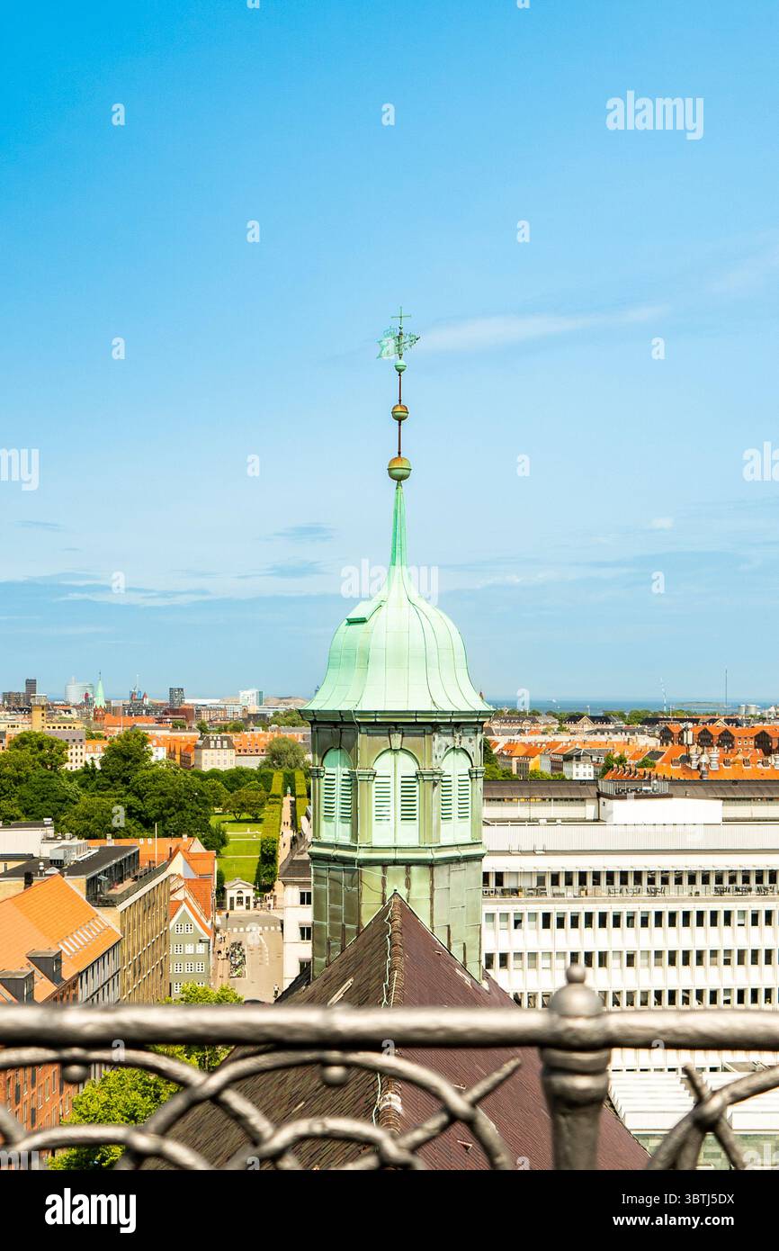 Green spire overlooking Copenhagen's rooftops from Rundetaarn terrace ...