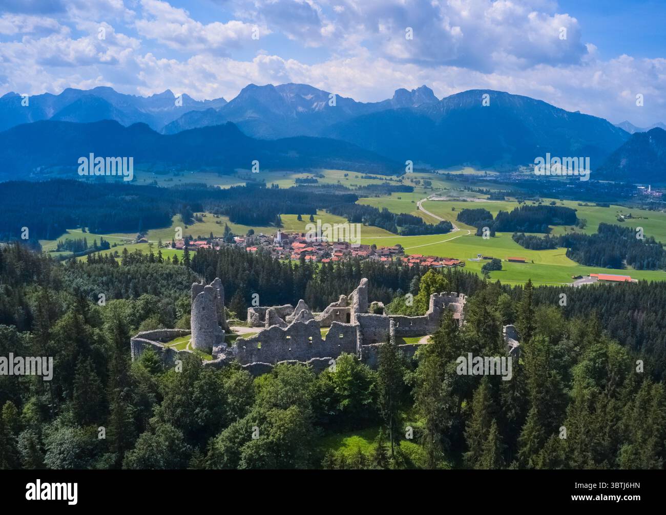Aerial view of the ancient castle ruins surrounded by emerald forests ...
