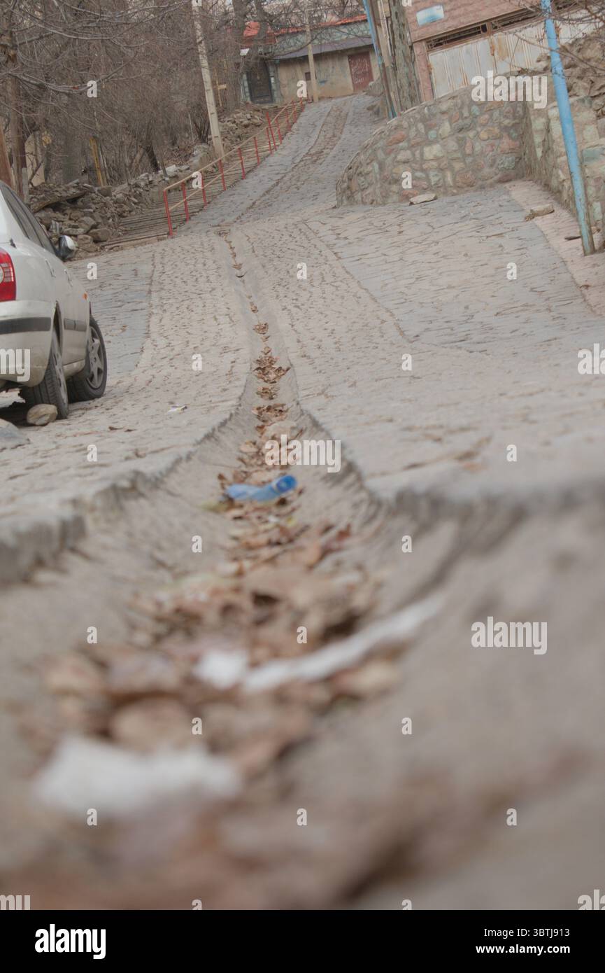 Stone stairs lead through a narrow alley in a hillside village near ...