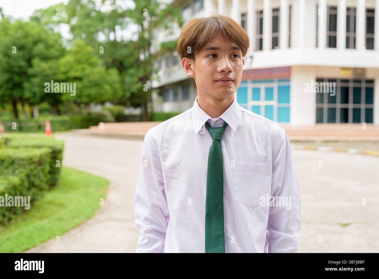 Non binary Asian university student in college campus Stock Photo - Alamy