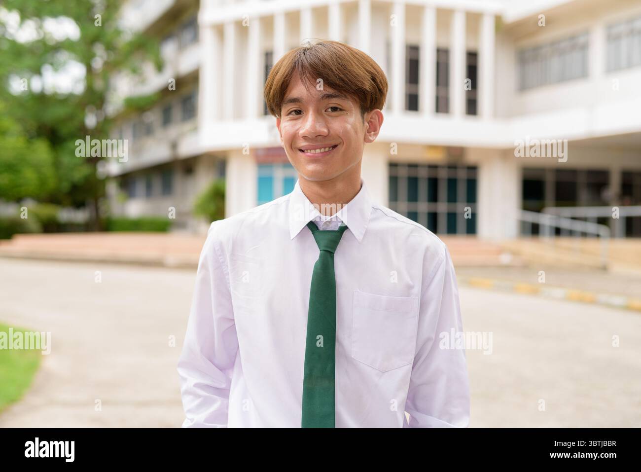 Non binary Asian university student in college campus Stock Photo - Alamy