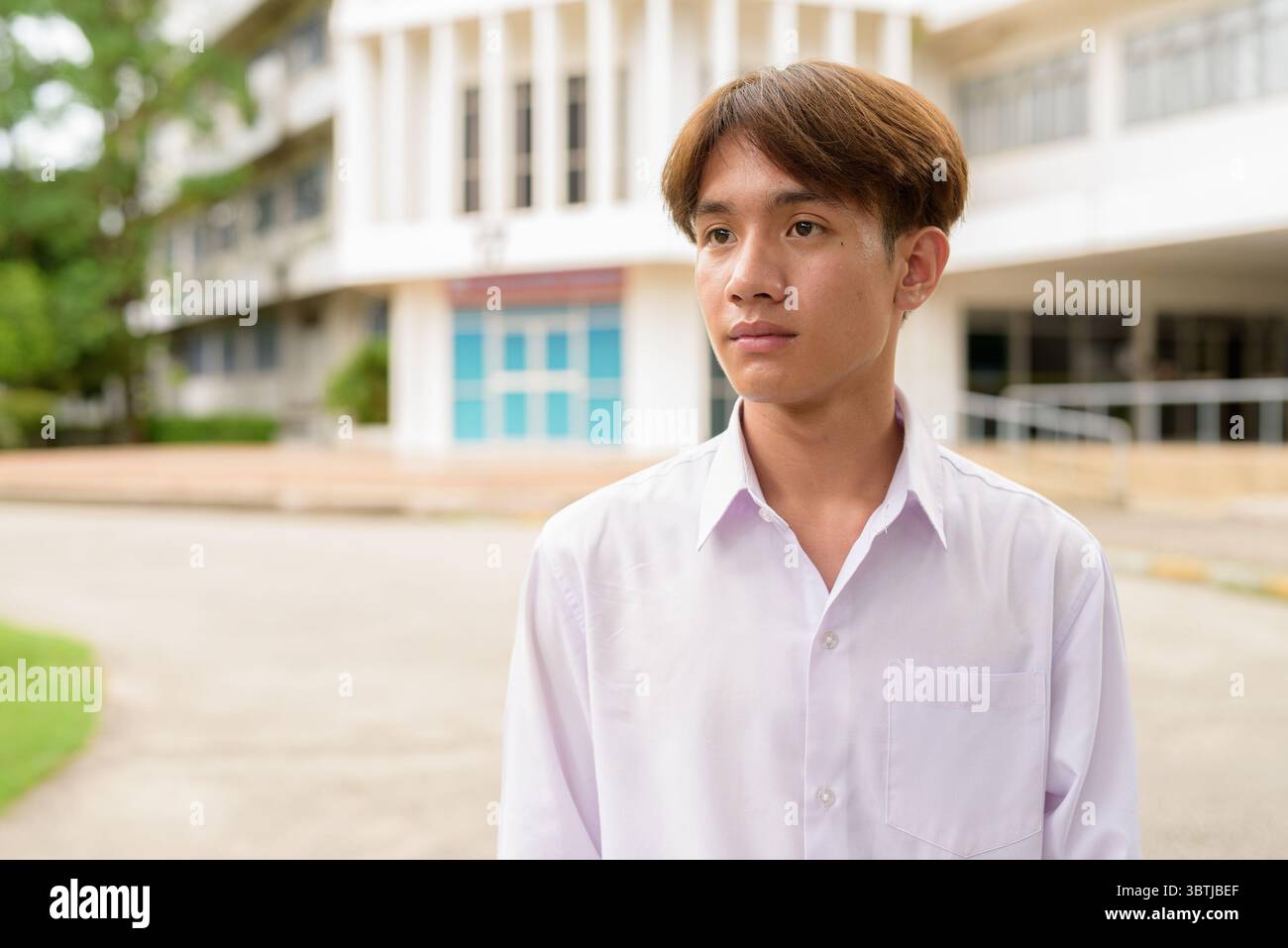 Non binary Asian university student in college campus Stock Photo - Alamy