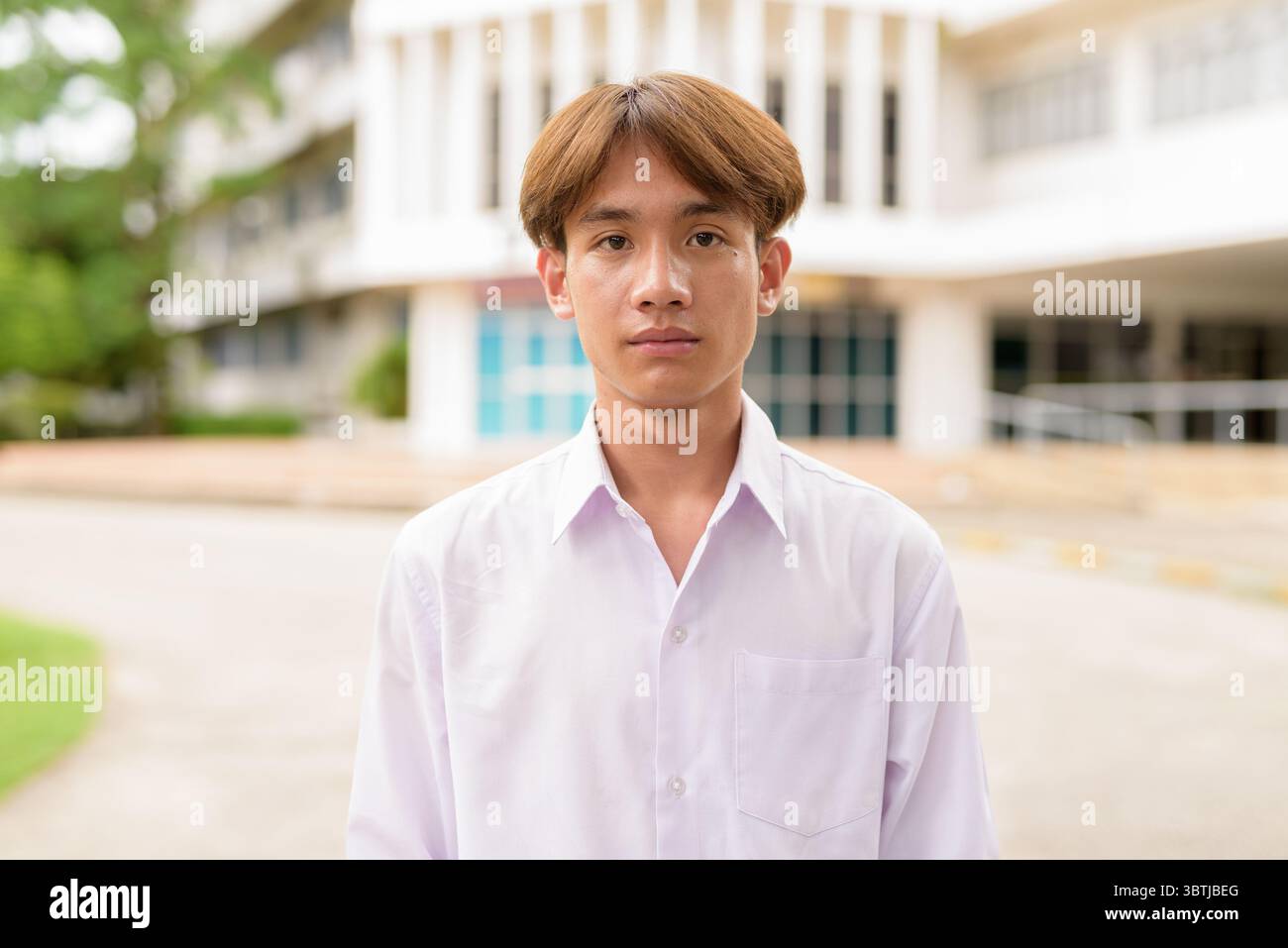 Non binary Asian university student in college campus Stock Photo - Alamy