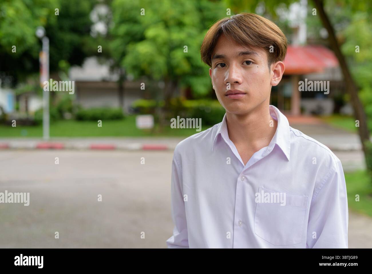 Non binary Asian university student in college campus Stock Photo - Alamy