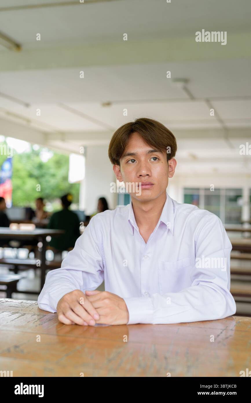 Non binary Asian university student in college campus Stock Photo - Alamy