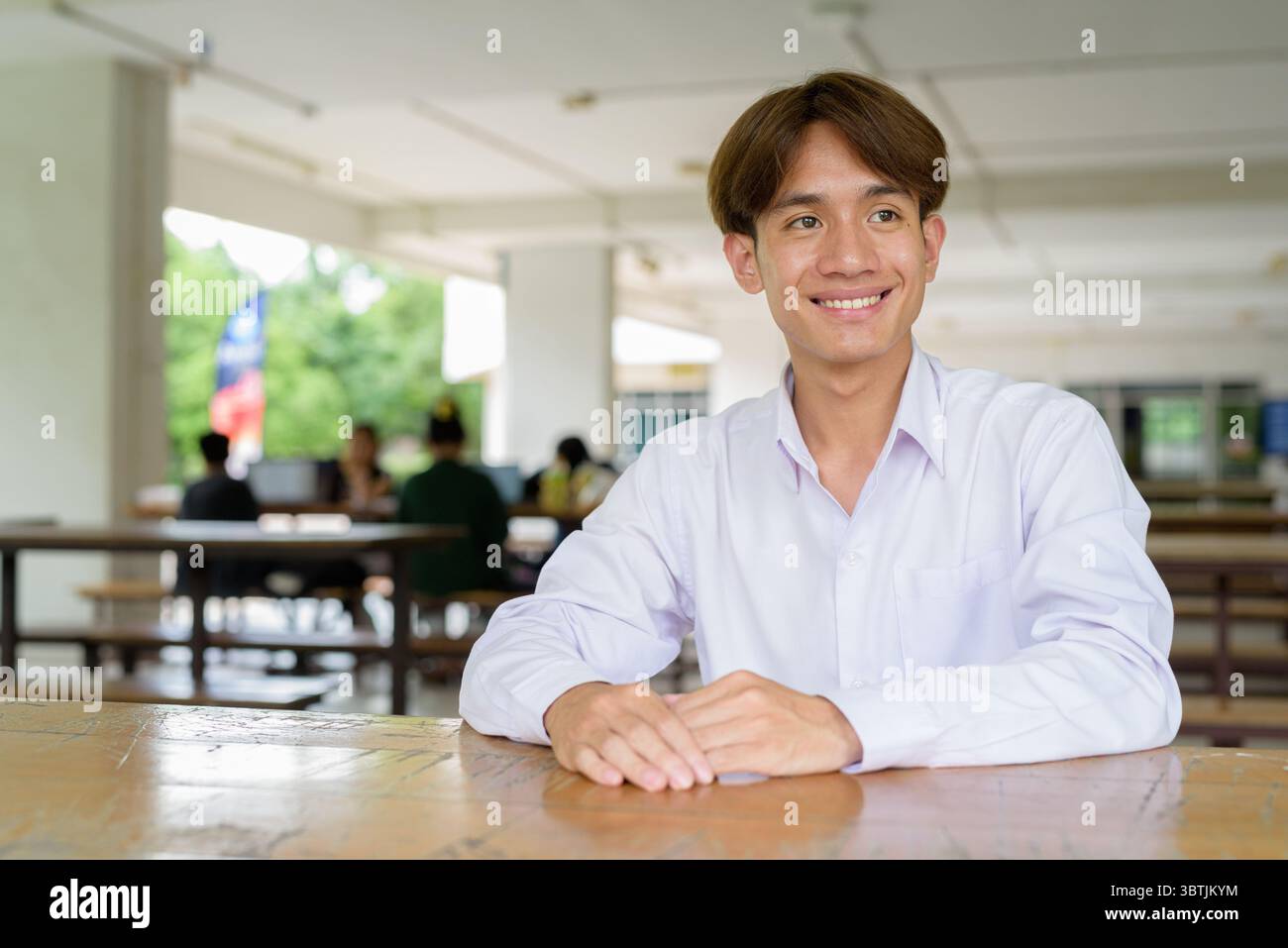 Non binary Asian university student in college campus Stock Photo - Alamy