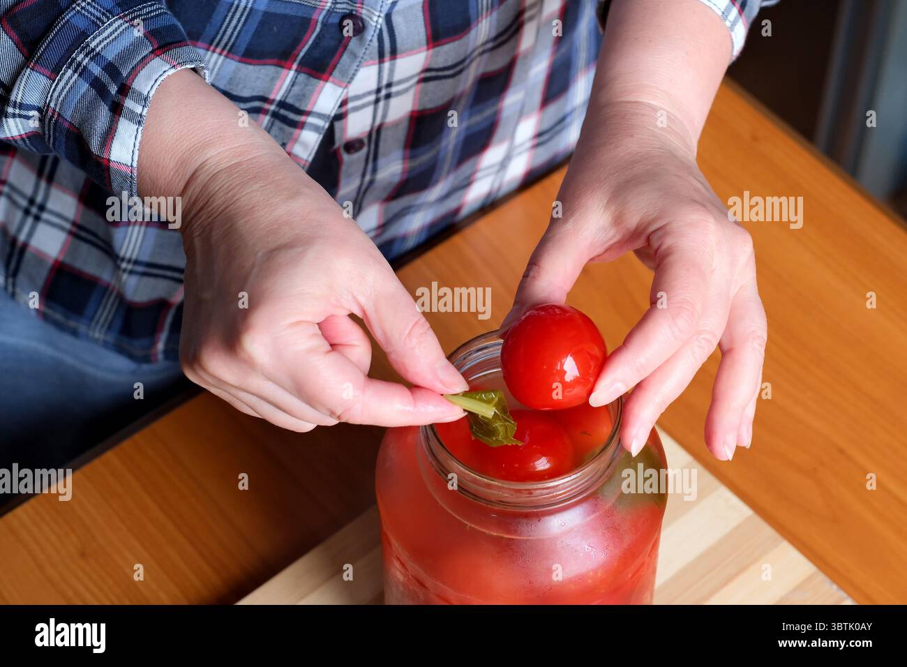 Take pickled tomatoes out jar hi-res stock photography and images - Alamy