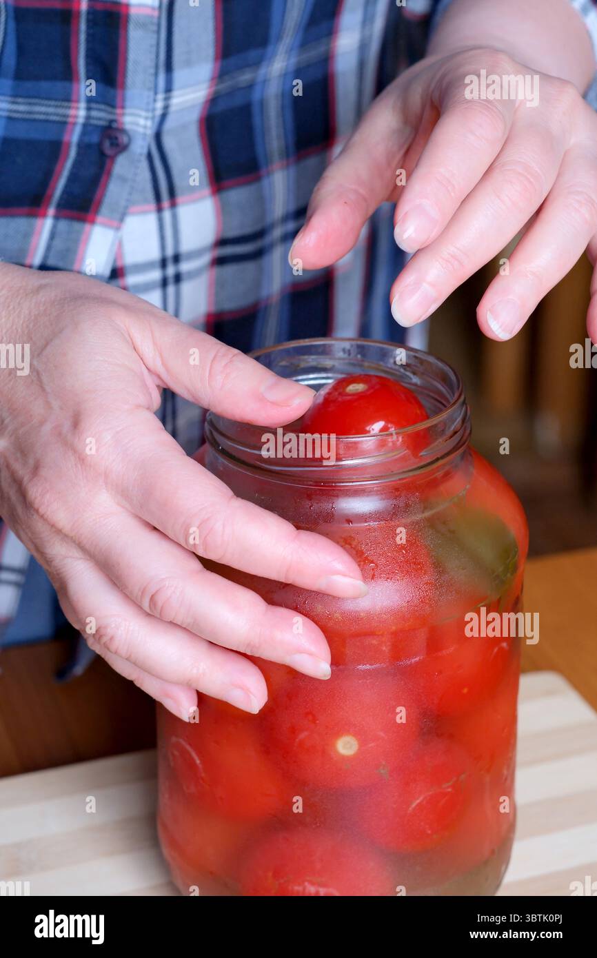 Take pickled tomatoes out jar hi-res stock photography and images - Alamy