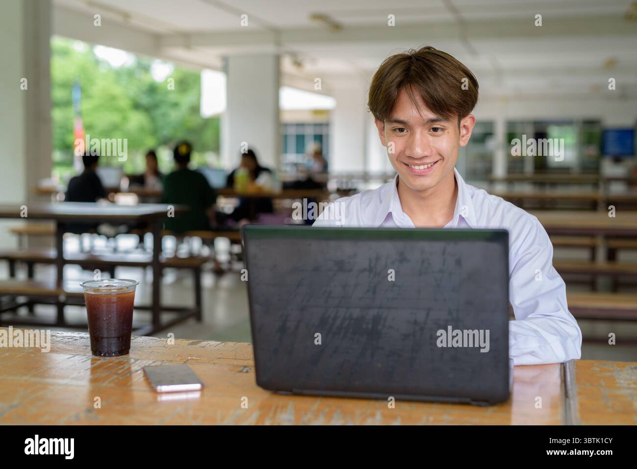 Non binary Asian university student in college campus Stock Photo - Alamy