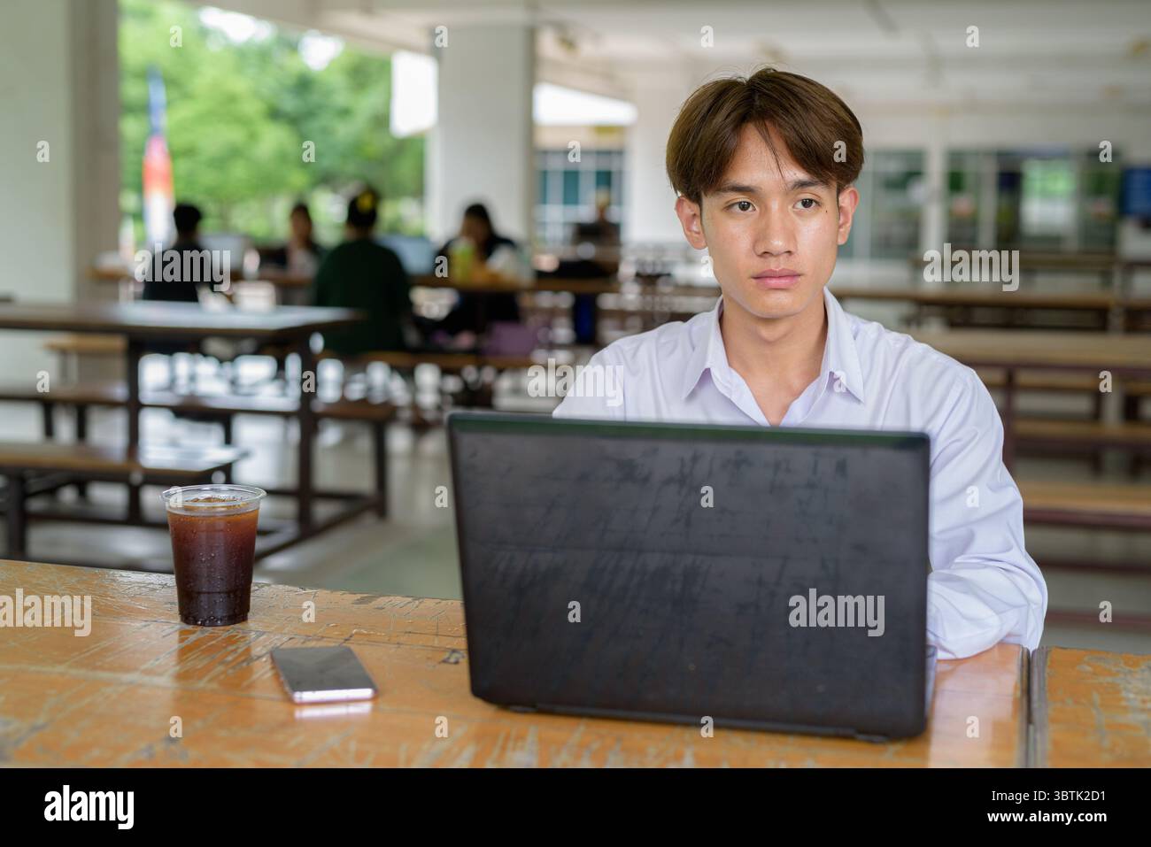 Non binary Asian university student in college campus Stock Photo - Alamy