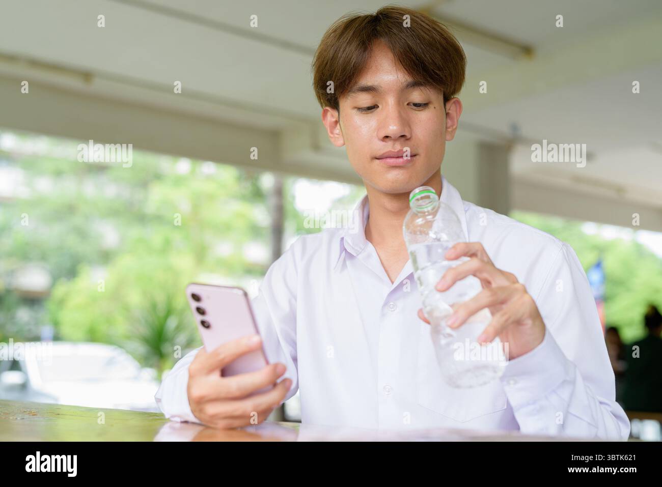 Non binary Asian university student in college campus Stock Photo - Alamy