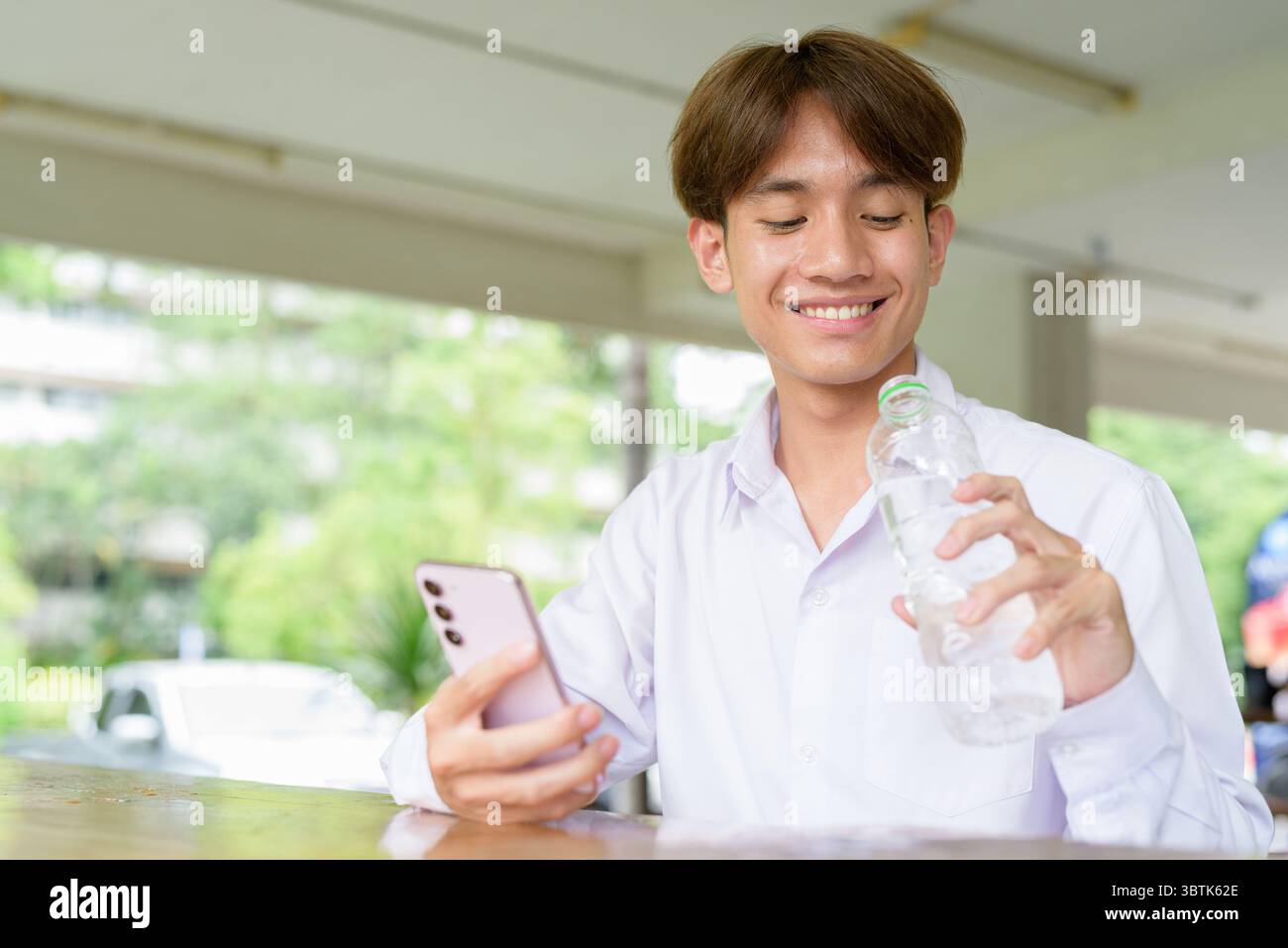 Non binary Asian university student in college campus Stock Photo - Alamy