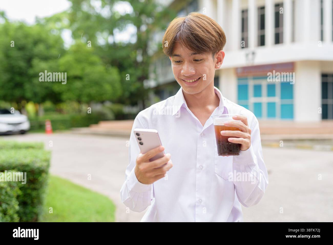 Non binary Asian university student in college campus Stock Photo - Alamy