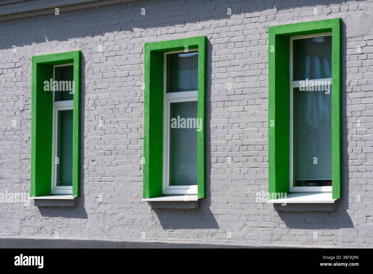 Architectural facade of an administrative building with green windows ...