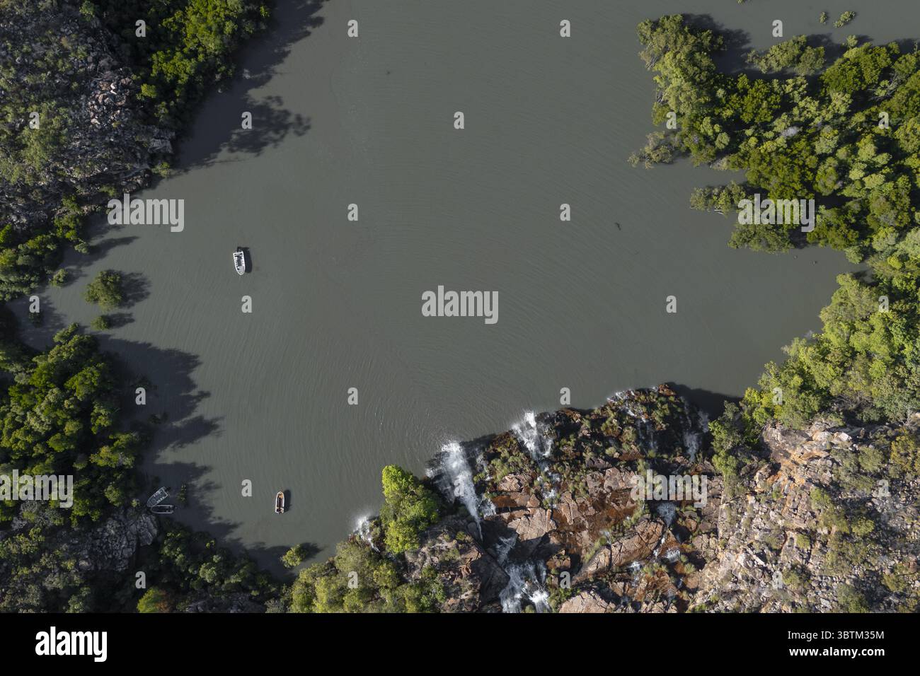 Aerial view of tranquil waters meet rugged cliffs and verdant ...