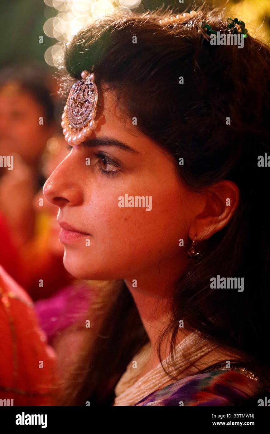 Close-up side view of a woman wearing a traditional tikka piece of ...