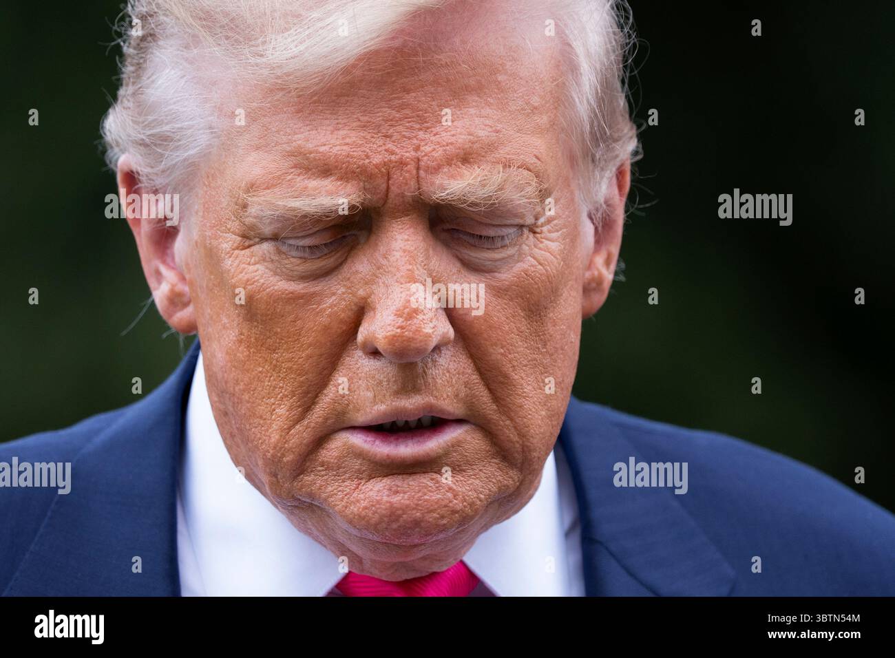 President Donald Trump walks to talk to the members of the media before ...
