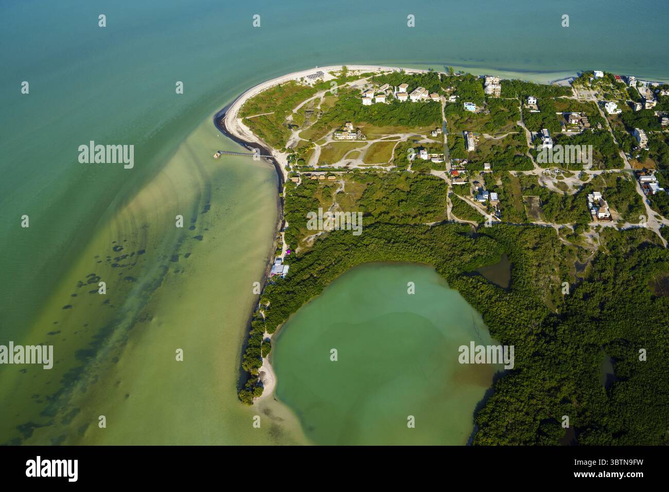 Aerial view of the coast blending into the green lagoon and the ...