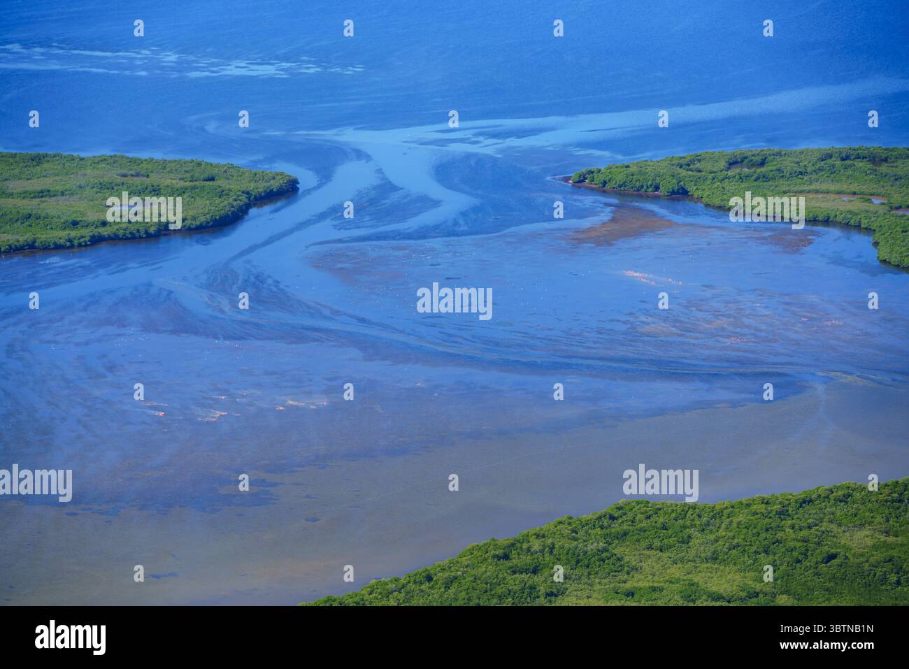 Aerial view of the bright blue waters flowing between islands of green ...