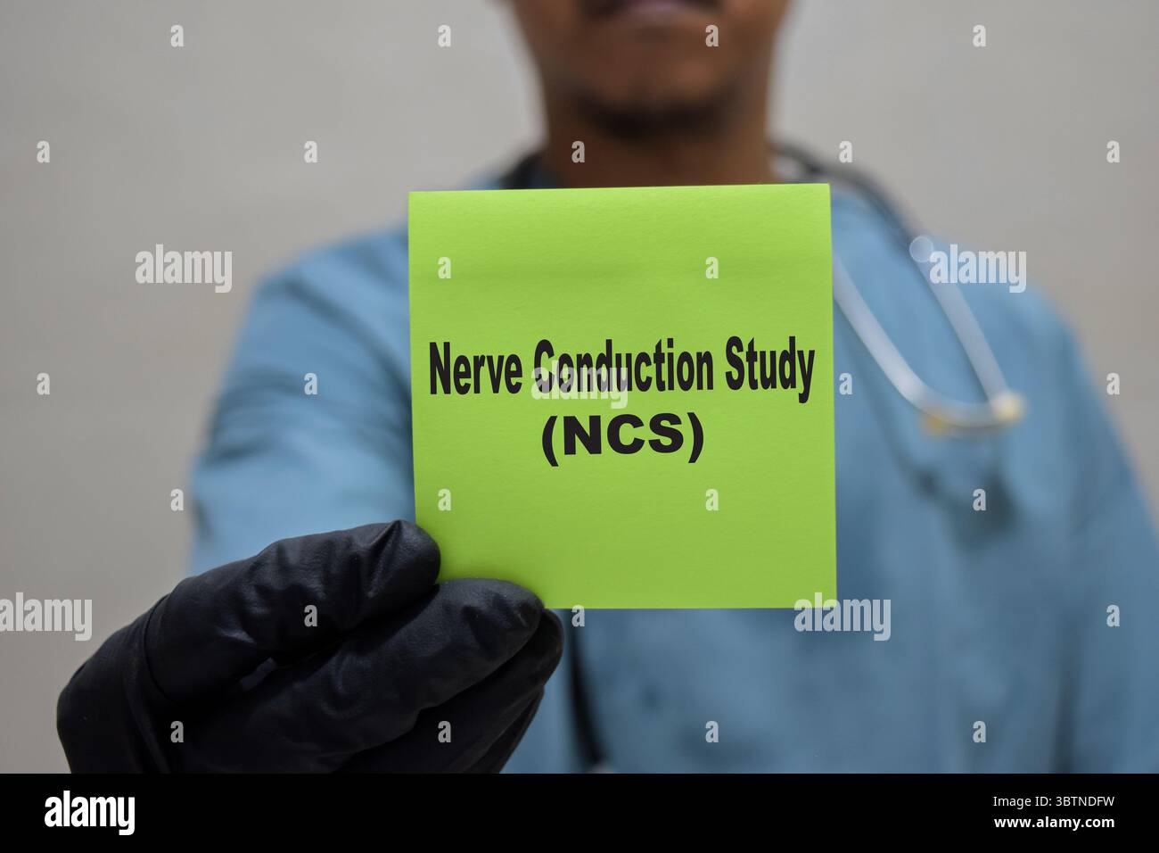 Doctor holds in hands a card with the name of the Nerve conduction ...