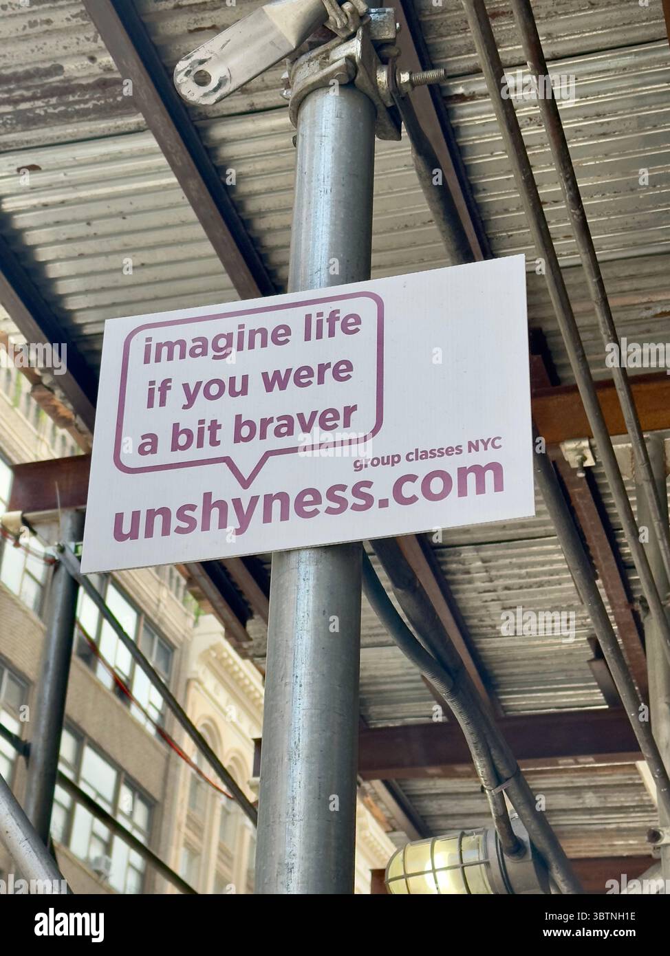 Advertising placard attached to building scaffold, New York City, New ...