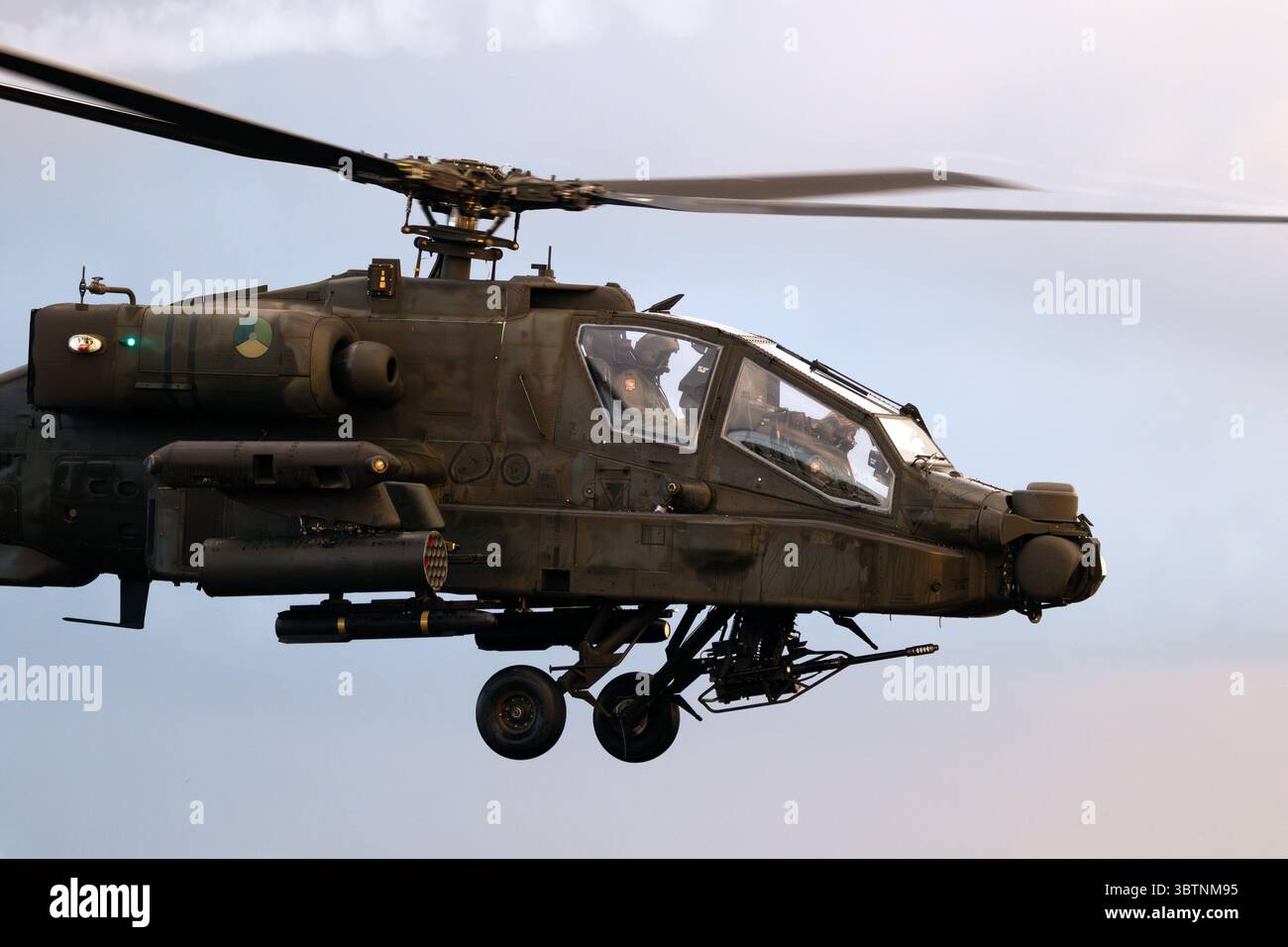 Boeing AH-64D Apache attack helicopter hovering, armed with pilot and ...