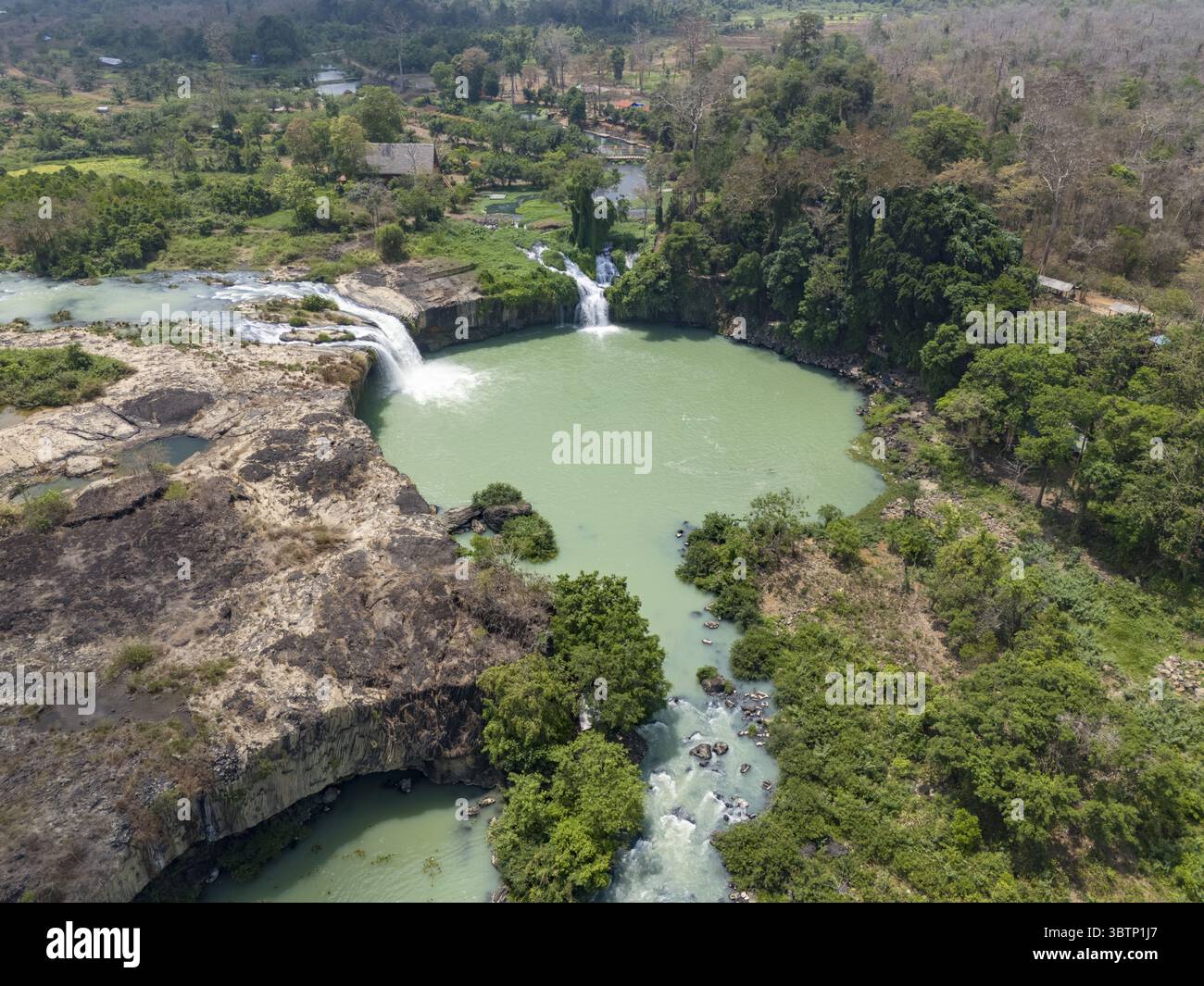 Aerial view of the Dray Nur Waterfall's milky green waters cascading ...