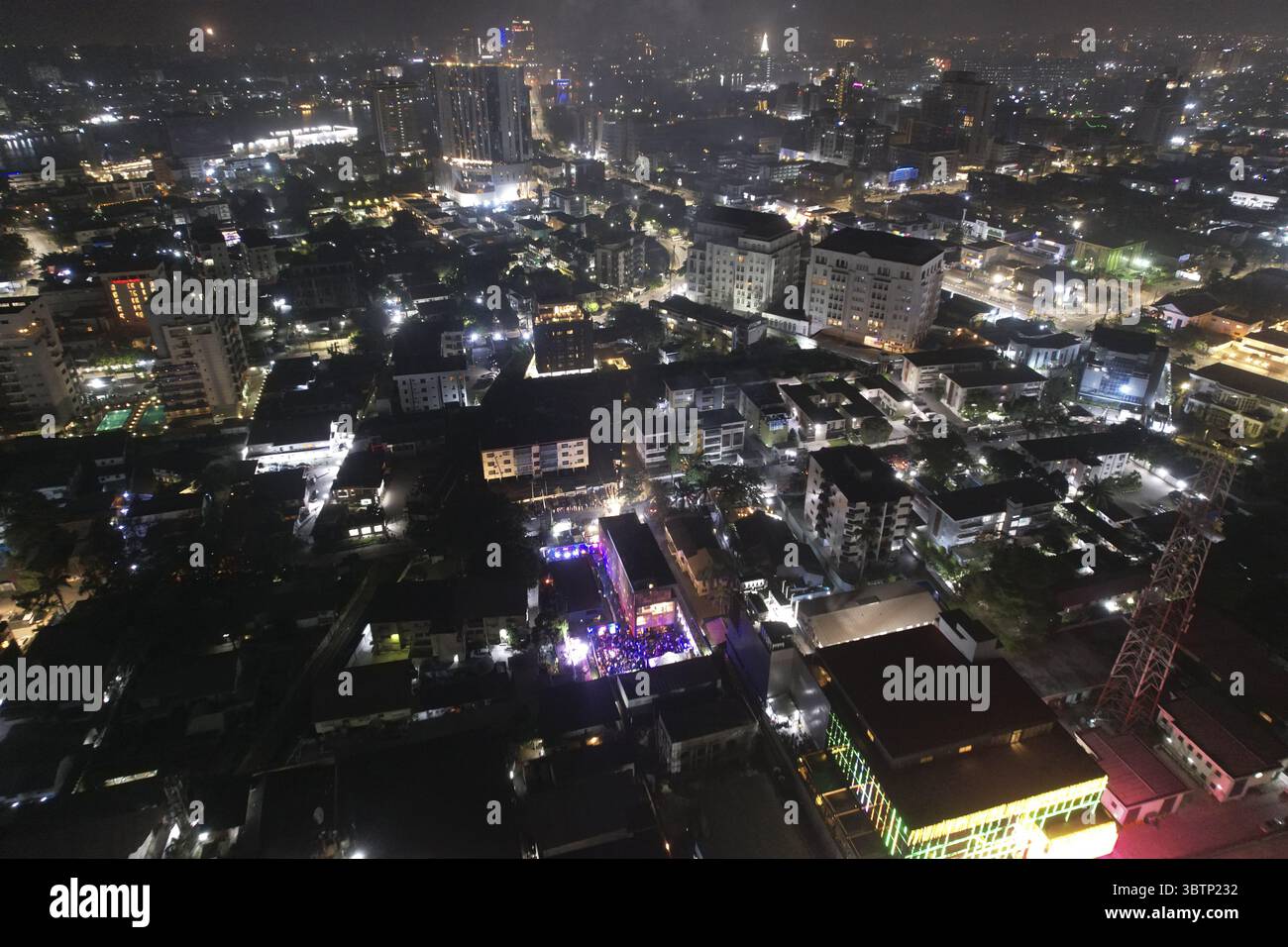 Aerial view of the cityscape ablaze with glittering lights illuminating ...