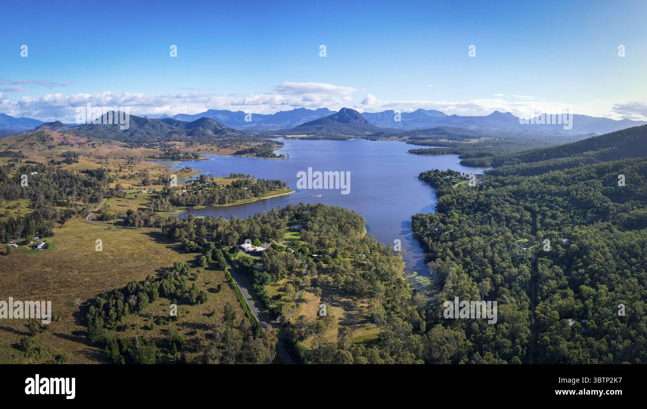 Aerial view of tranquil waters mirroring the sky, embraced by lush ...